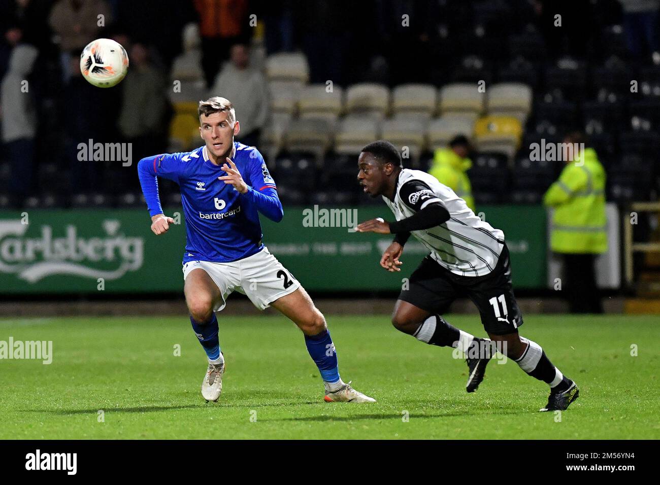 Nottingham, UK. 26th Dec, 2022. Mark Kitching of Oldham Athletic tussles with Aaron Nemane of ...