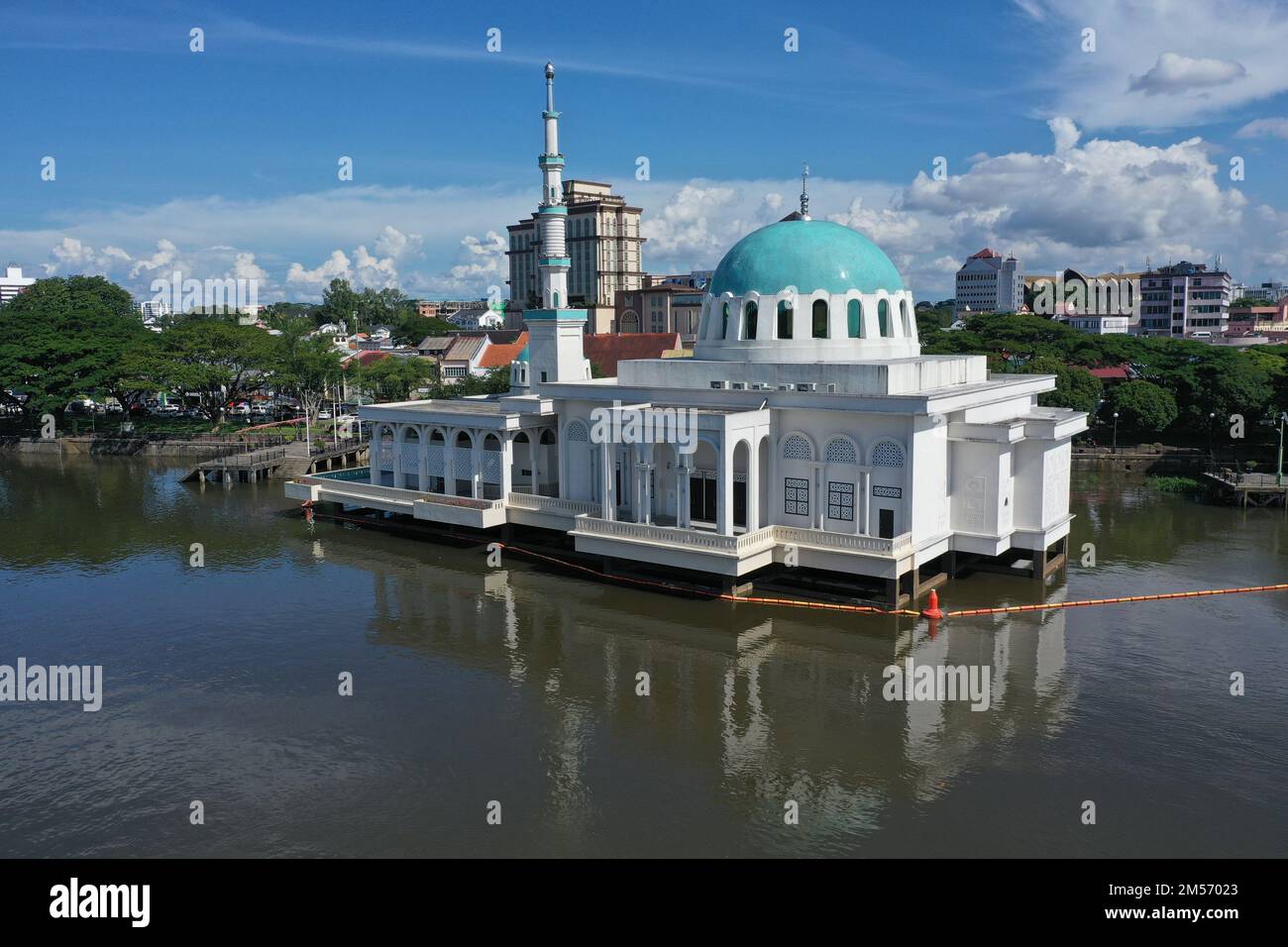 Drone photo of white mosque with green dome at the waterfront river in ...