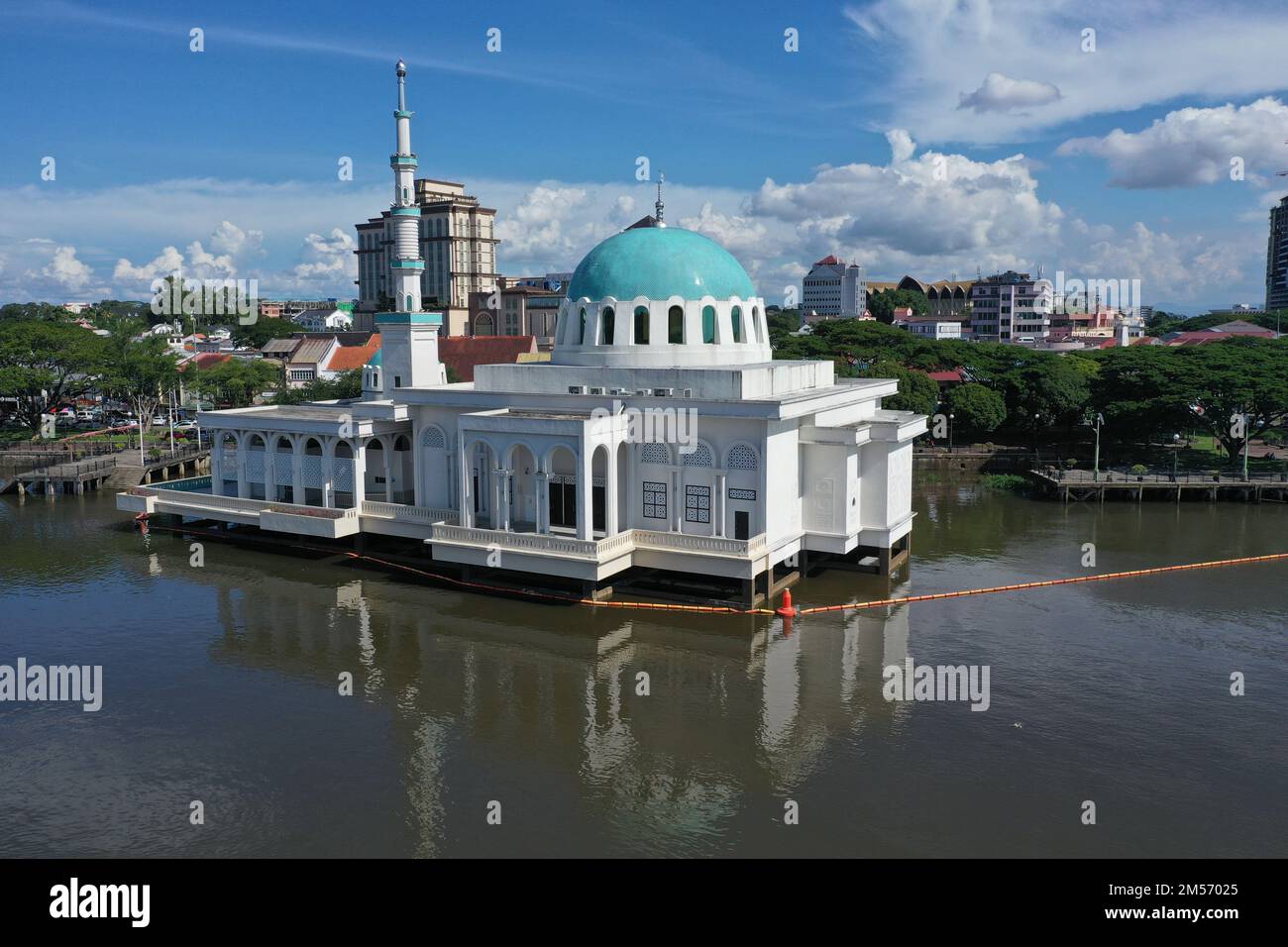 Drone photo of white mosque with green dome at the waterfront river in Kuching, Sarawak ...