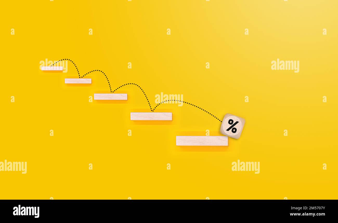 A cube on a yellow background with decreasing interest. Interest rates ...