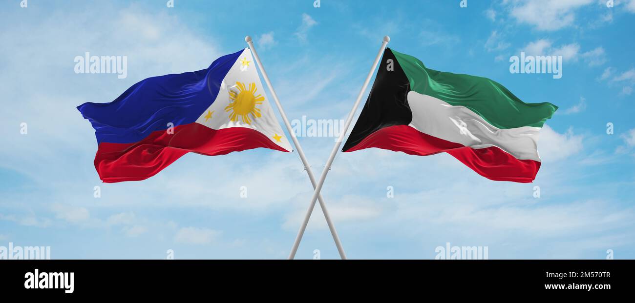 two crossed flags Kuwait and Philippines waving in wind at cloudy sky ...