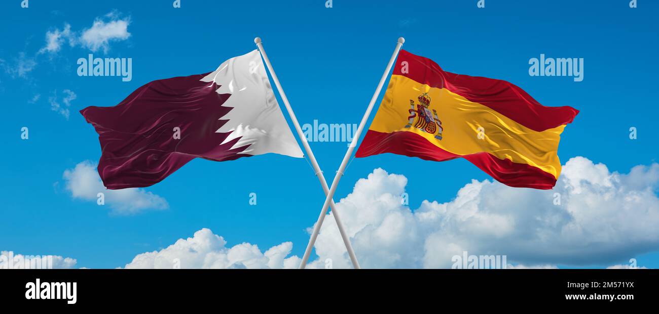 two crossed flags Spain and Qatar waving in wind at cloudy sky. Concept ...