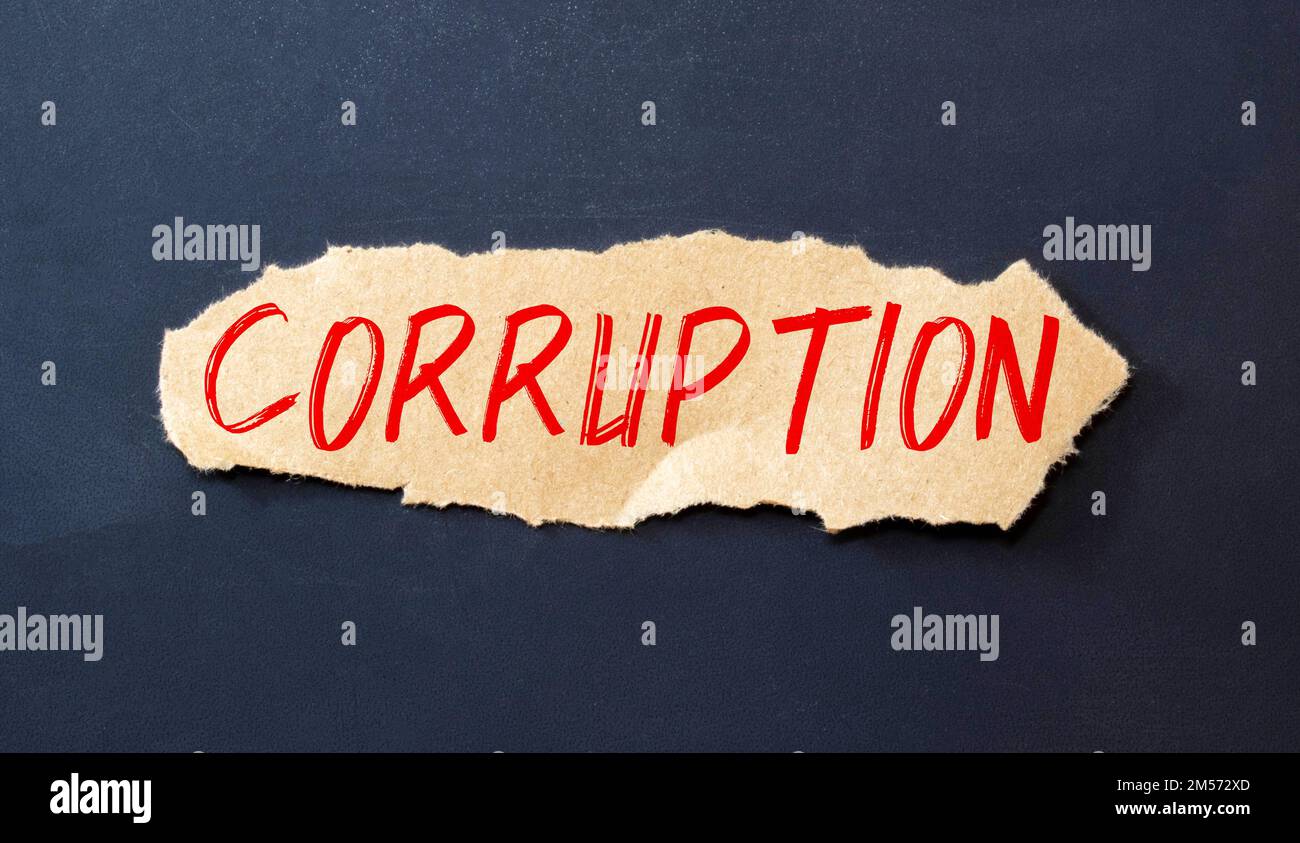 View on word CORRUPTION through torn paper Stock Photo - Alamy