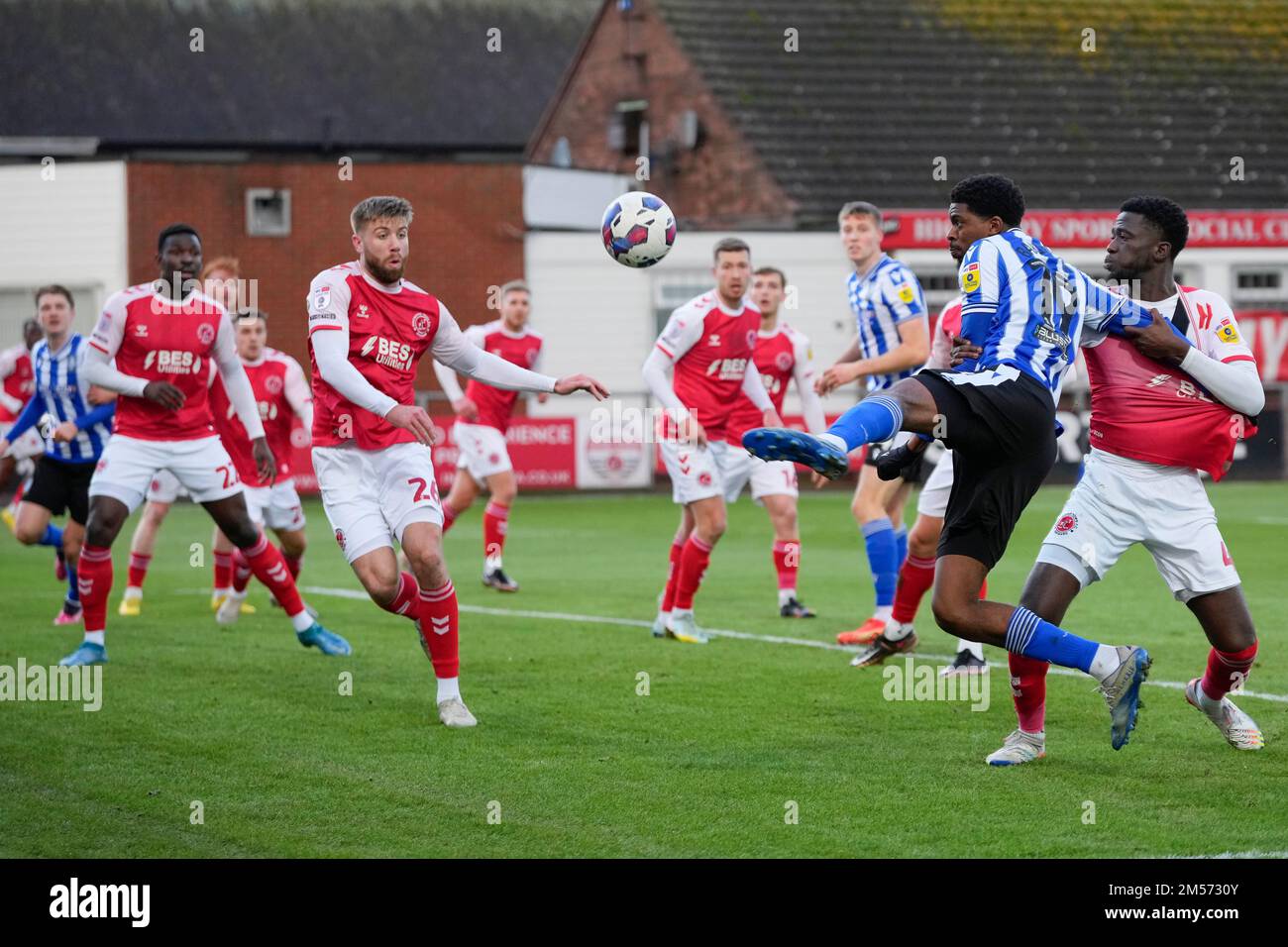 Tyreeq Bakinson #19 of Sheffield Wednesday is held by Brendan Sarpong ...