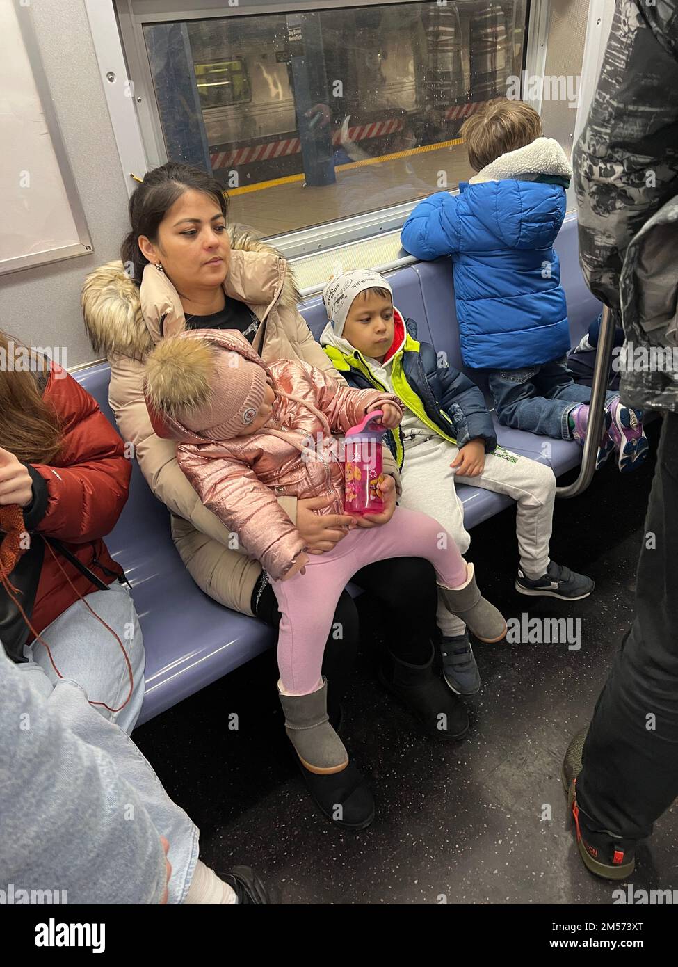 Children with mom ride a New York City subway F train from Brooklyn to ...