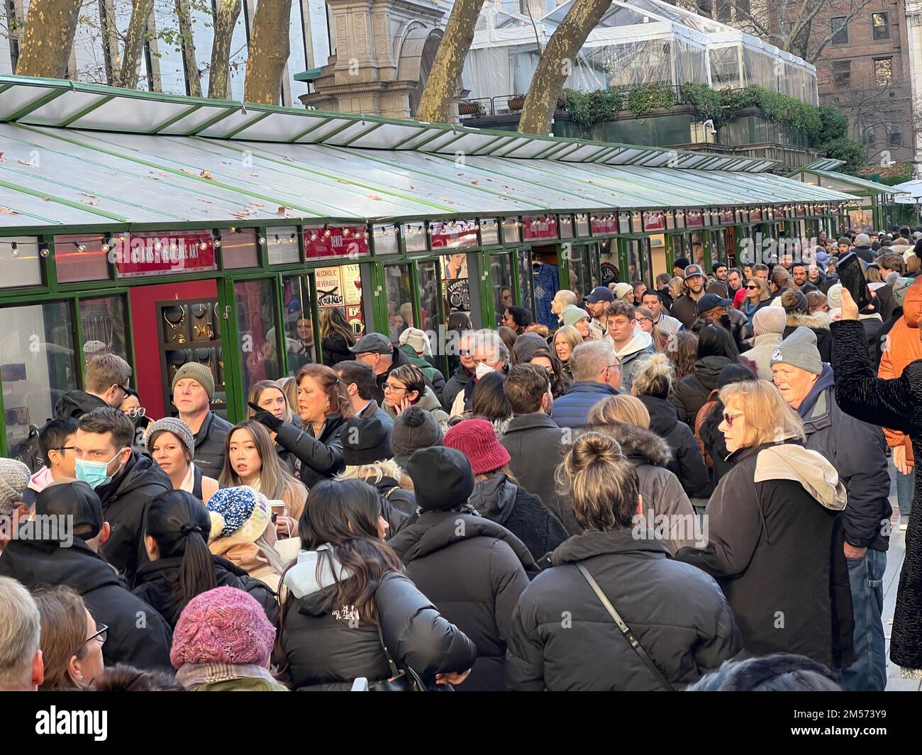 Crowds of people at the holiday shopping village at Bryant Park a week ...
