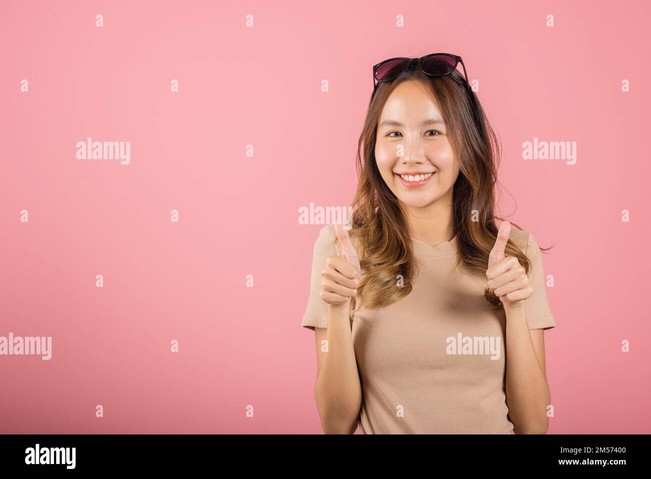 woman smiling she standing made finger thumbs up Stock Photo - Alamy