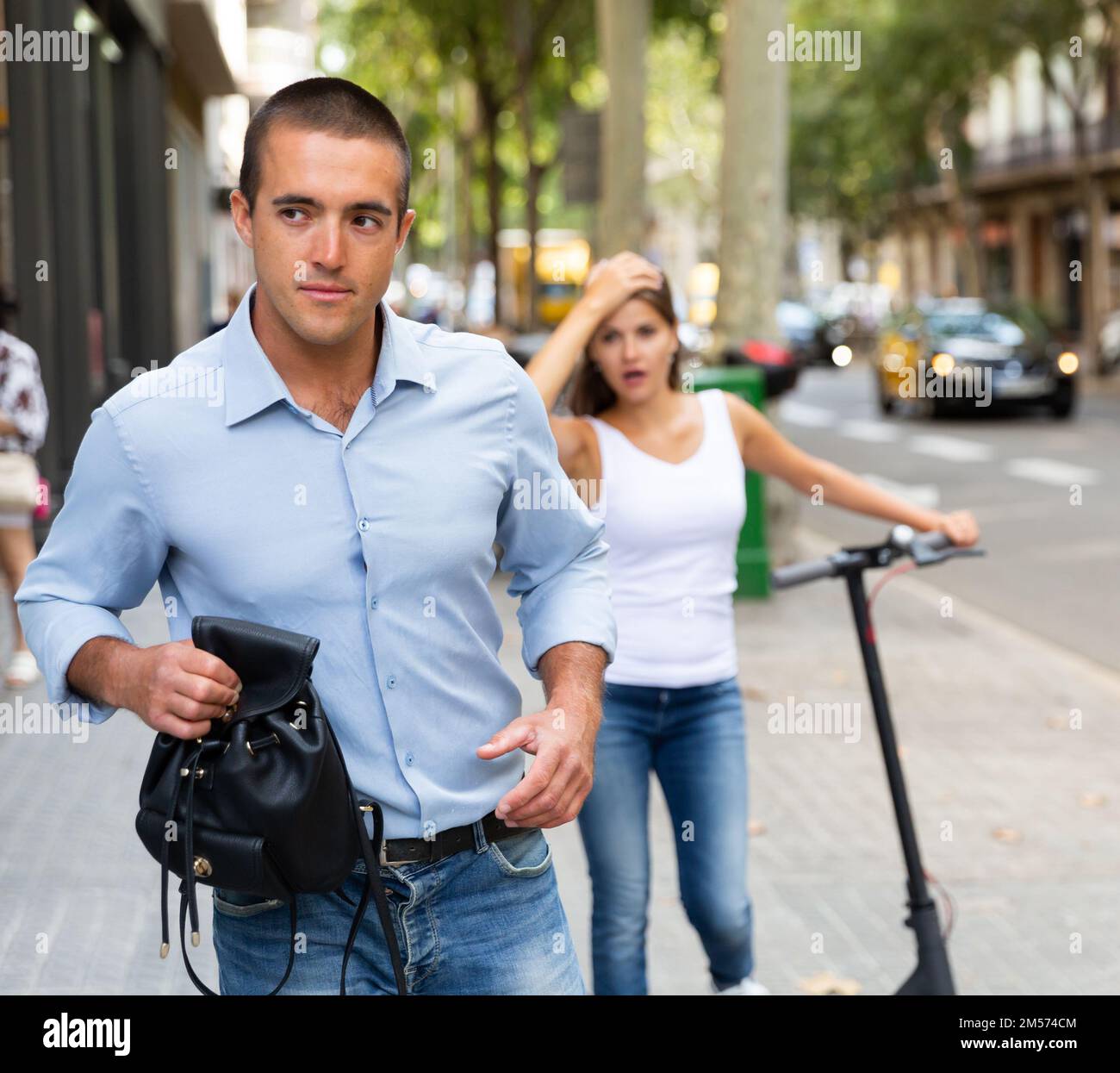 Thief stealing bag from woman riding scooter Stock Photo - Alamy