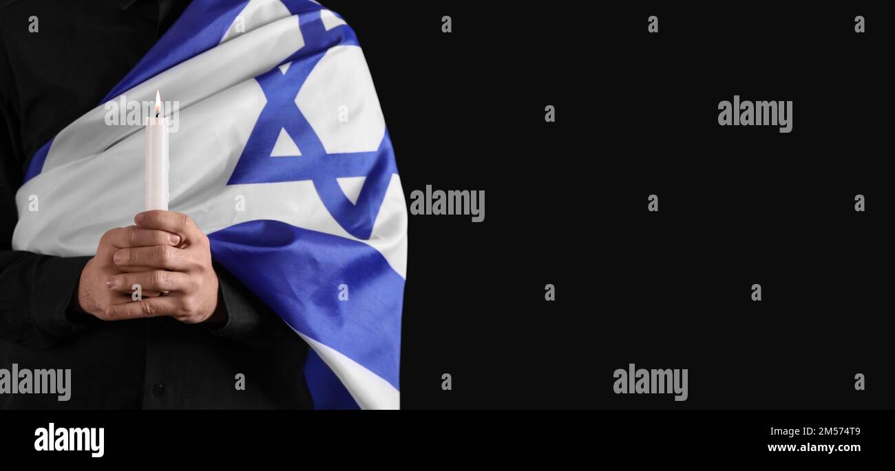 Jewish man with burning candle and flag of Israel honoring victims of ...