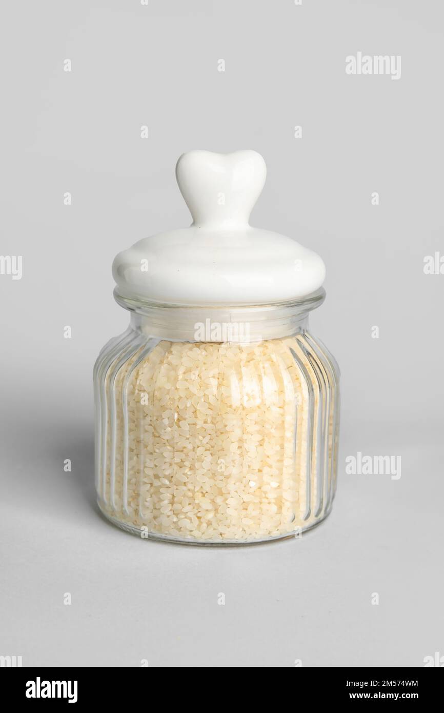 Glass jar of rice on white background Stock Photo - Alamy