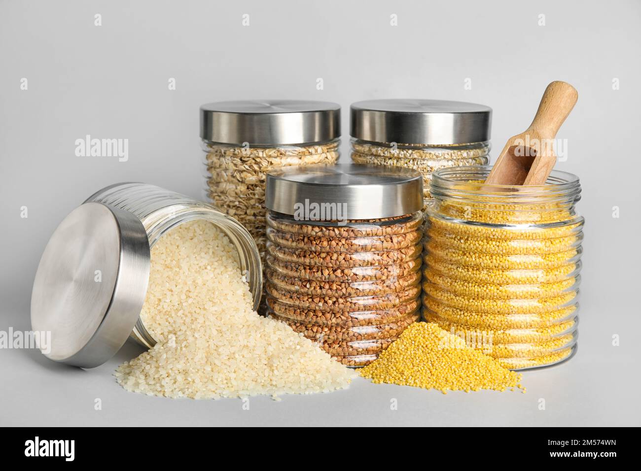 Glass jars with different cereals on white background Stock Photo - Alamy