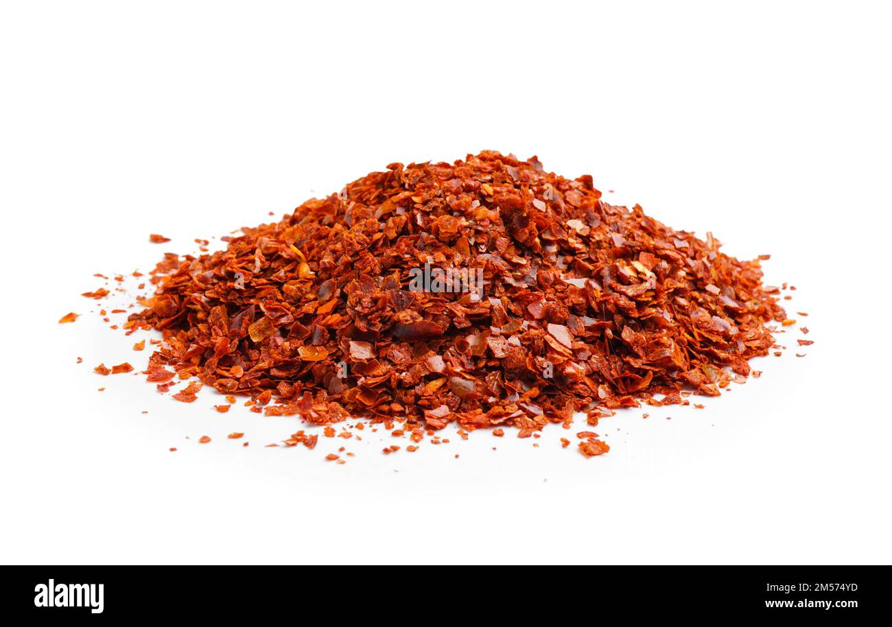 Heap of chipotle chili flakes on white background Stock Photo - Alamy