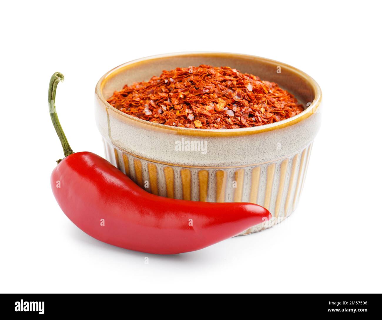 Bowl with chipotle chili flakes on white background Stock Photo - Alamy