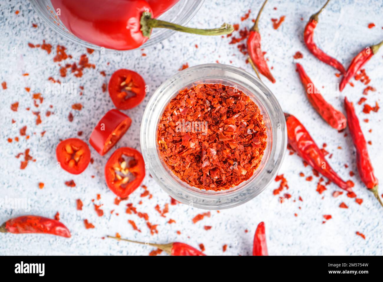 Glass of chipotle chili flakes on light background Stock Photo - Alamy