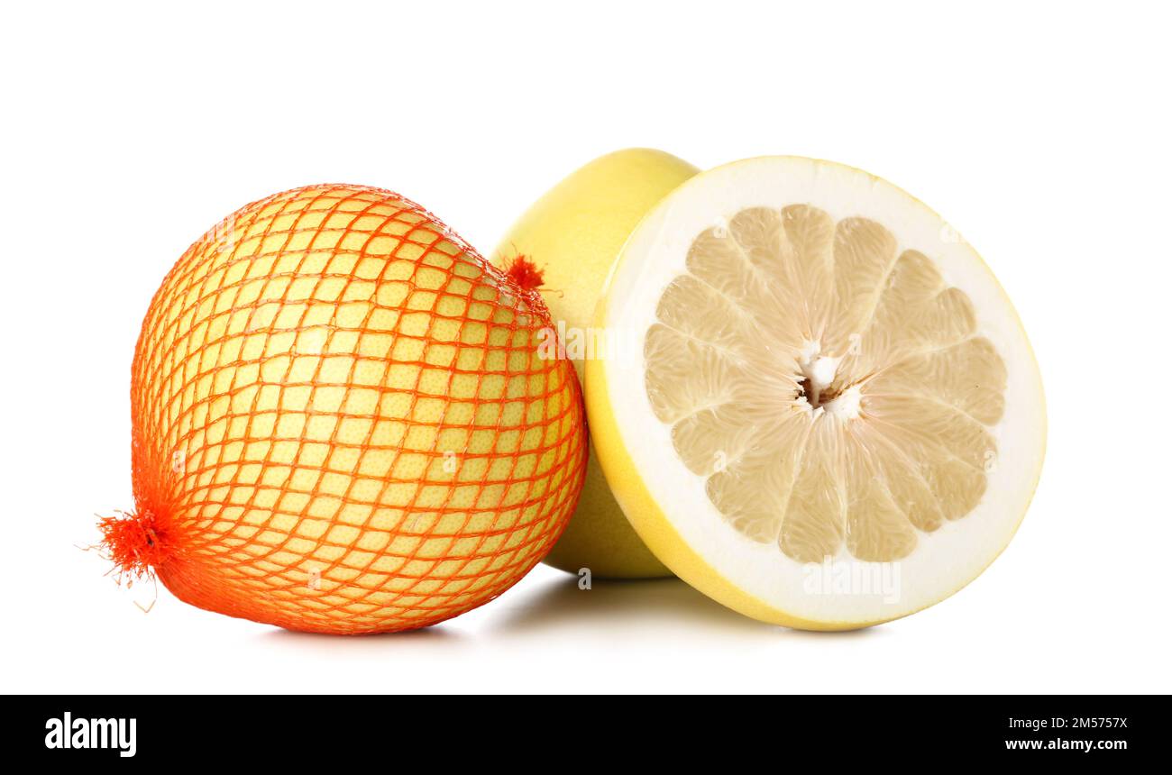 Whole and cut sweet ripe pomelo fruits on white background Stock Photo ...