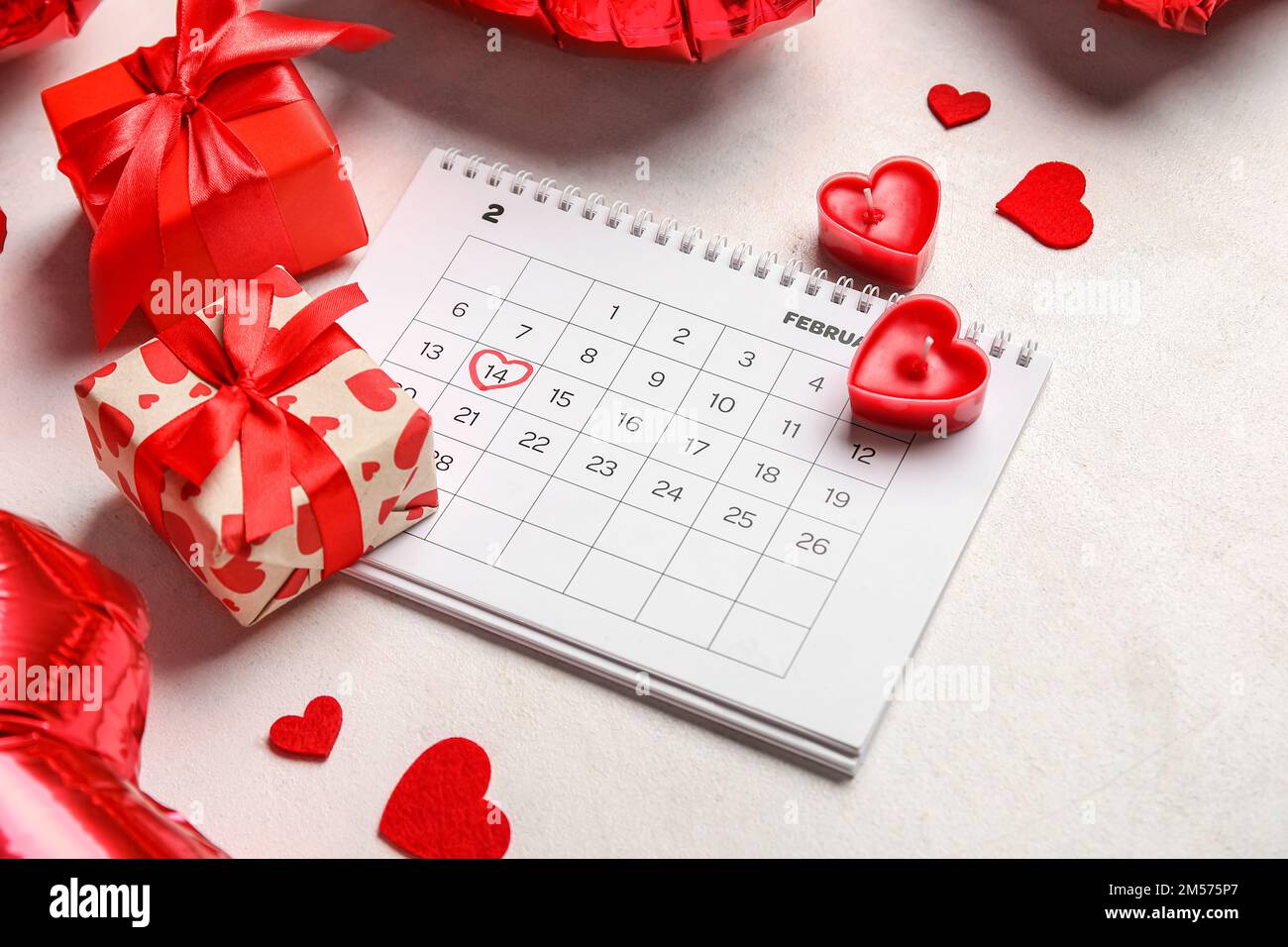 Calendar with marked date of Valentine's Day, candles and gifts on ...