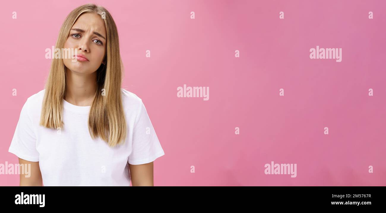 Sad girl whining tilting head raising eyebrows in upset expression and ...