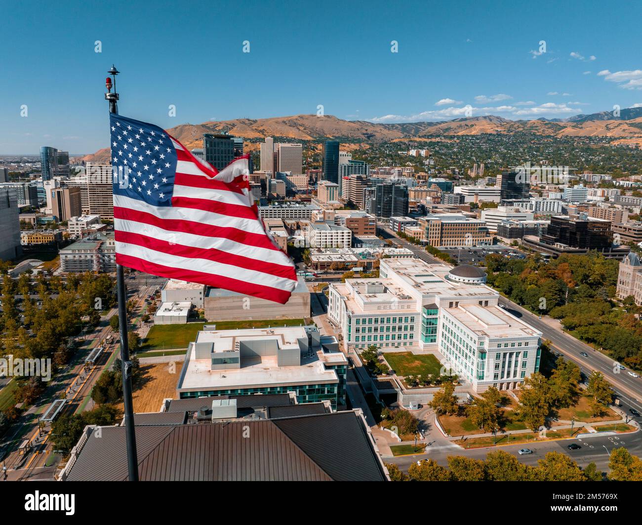 American flag waving on top of the building Stock Photo - Alamy