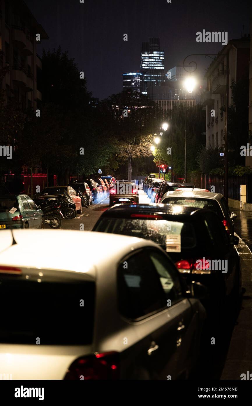 A rainy and jammed road in Paris, France with towers in the background ...
