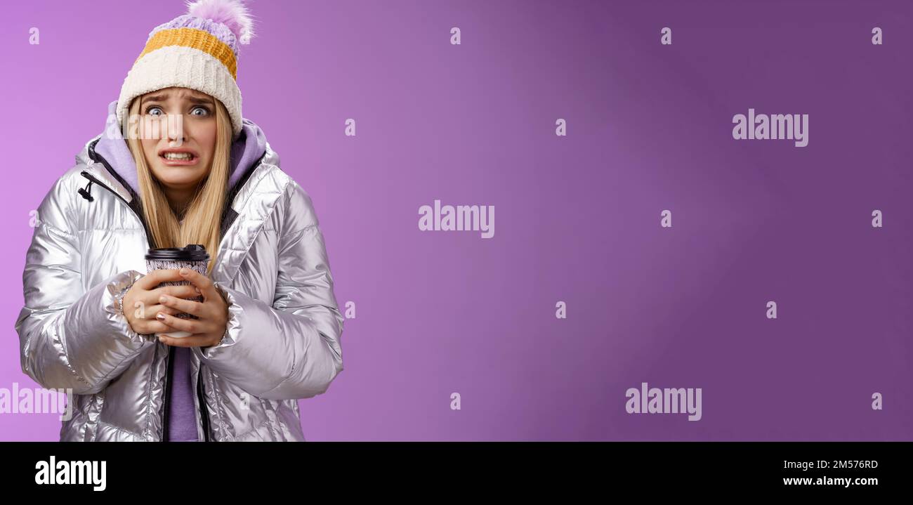 Shaking uncomfortable displeased girl wearing stylish silver jacket hat ...