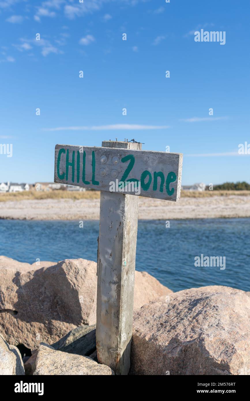 Relaxing photo, image of a wooden sign with post on a beach with water ...
