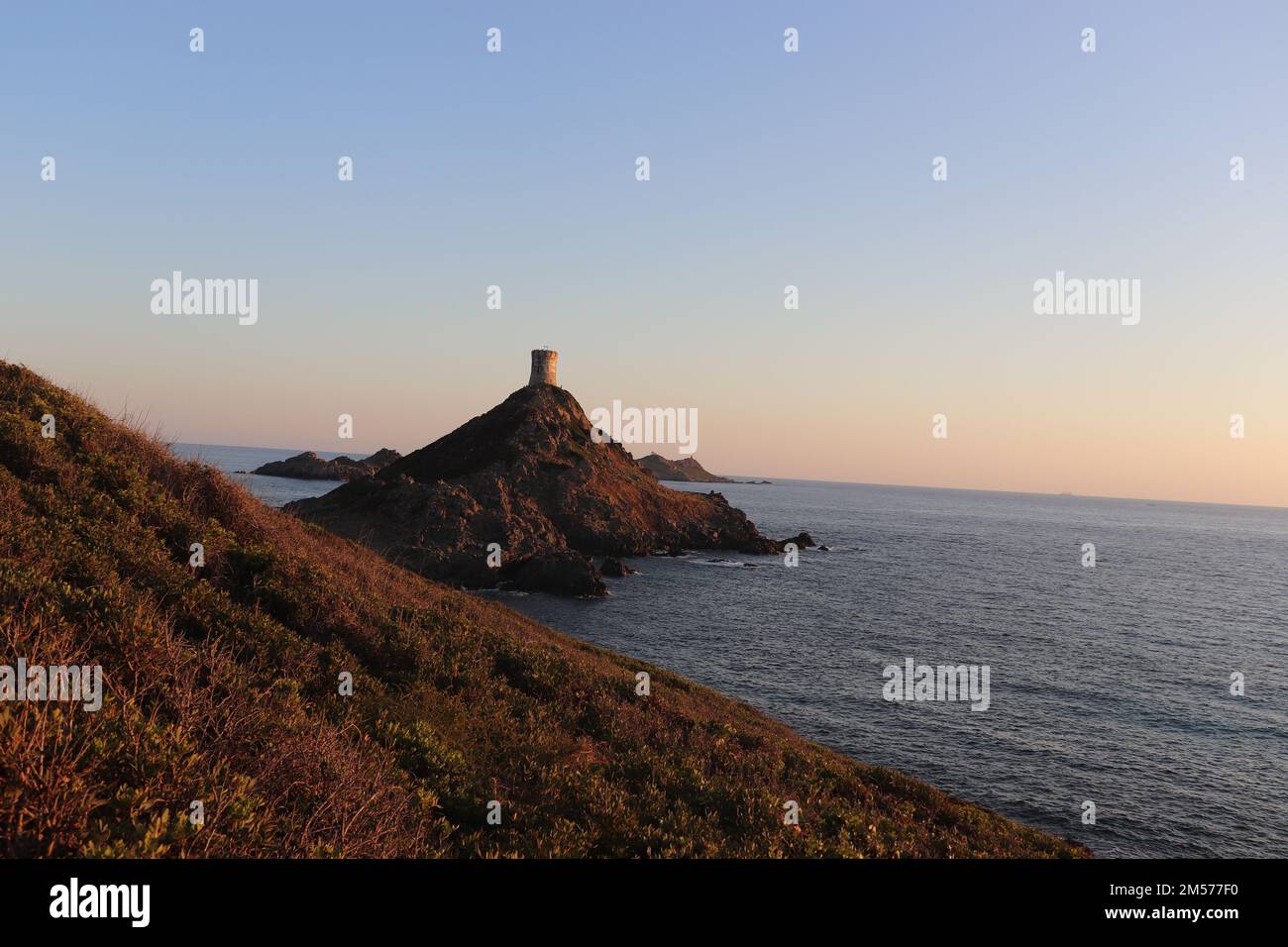 A scenic shot of the Pointe de la Parata island with the evening sun ...