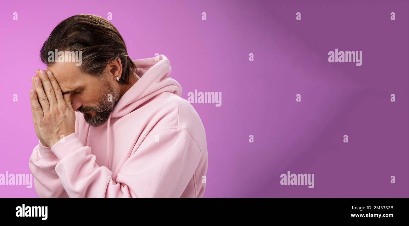 Concerned upset man supplicating asking god mercy help praying bow head ...