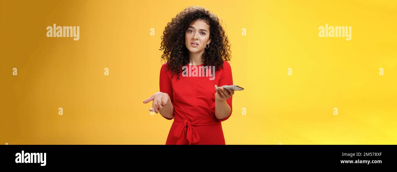 So waht, I confused. Questioned uncertain woman with curly hair in red ...