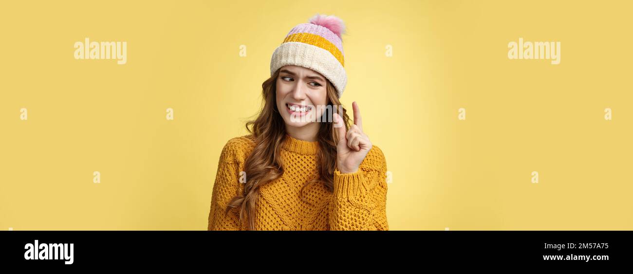 Displeased attractive picky woman describing small object show tiny ...