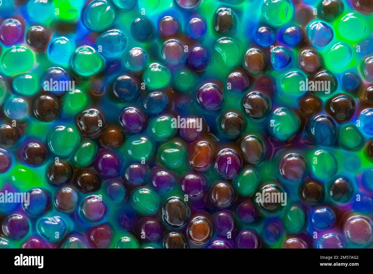Hydrogel Orbeez background.Blue green orbiz balls in water.Hydrogel ...