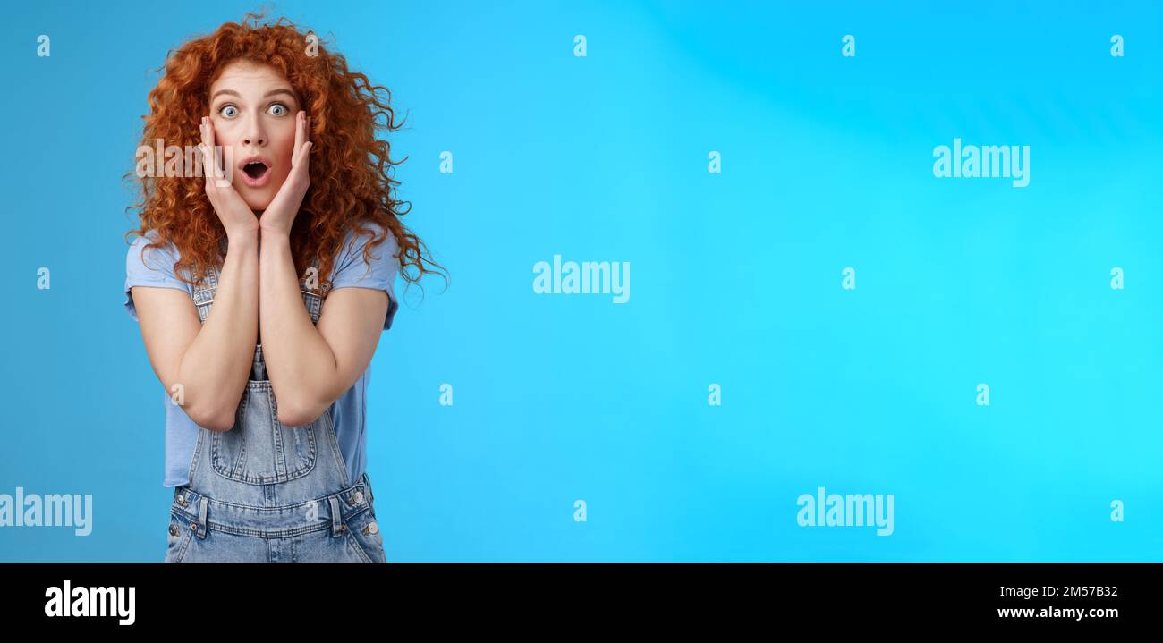 Amazed gasping shocked wondered redhead attractive curly girl popping ...
