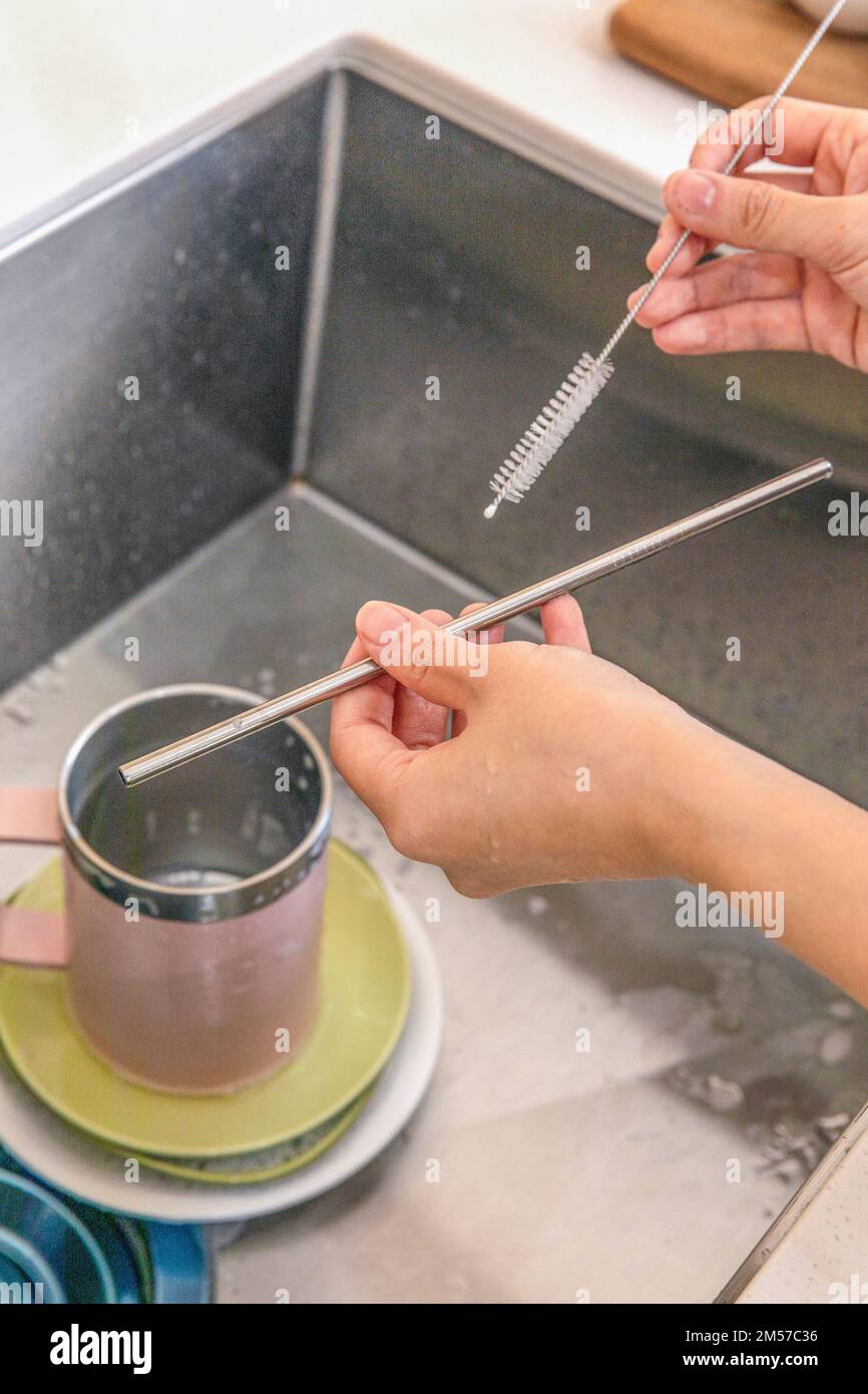 eco friendly habits hand gesture washing the stainless steel straw ...