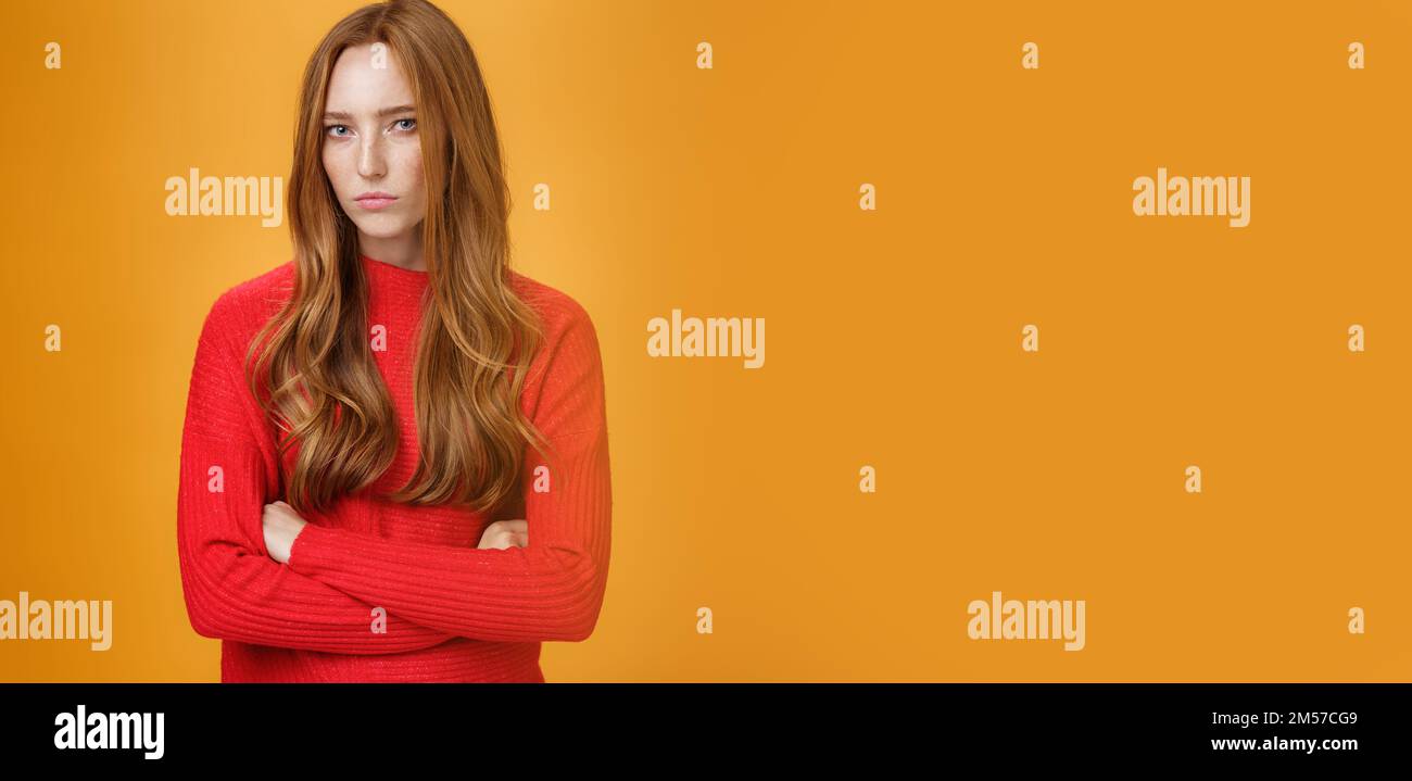 Suspicious intense and defensive ginger girl standing in passive ...