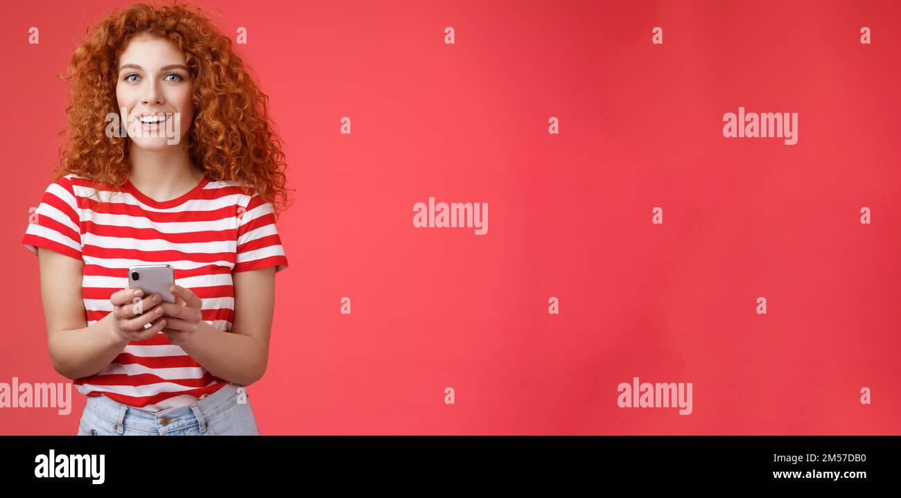 Fashionable carefree good-looking relaxed redhead girlfriend hold ...