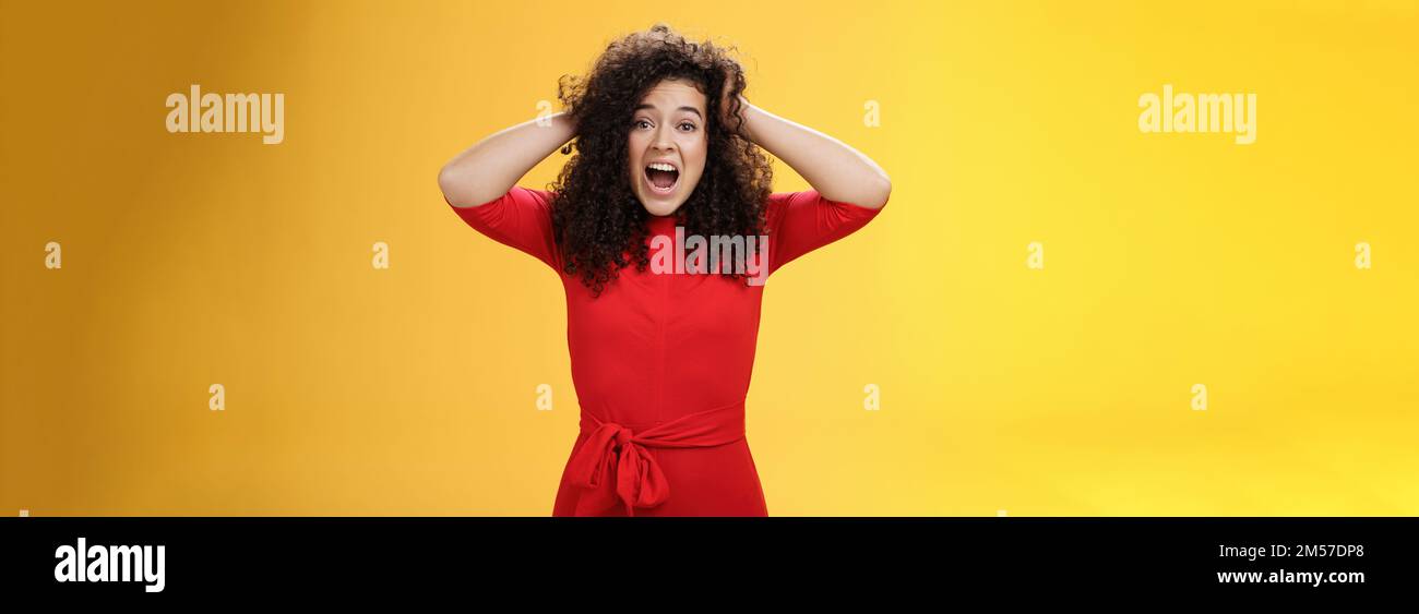 Girl feeling pressure standing anxious in panic holding hands on curly ...