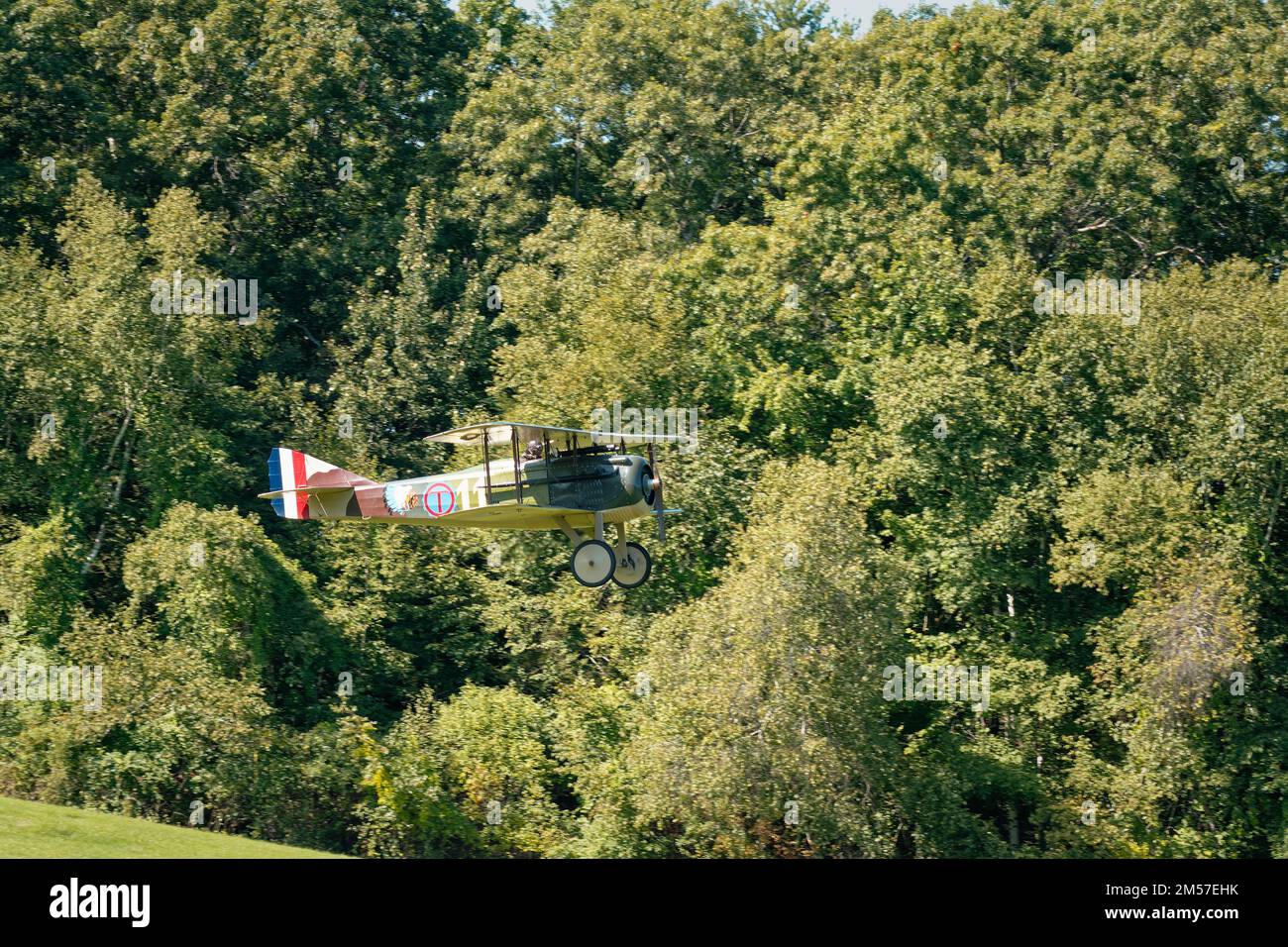 A 1914 French WWI Nieuport 11 biplane flying maneuvers during a war ...
