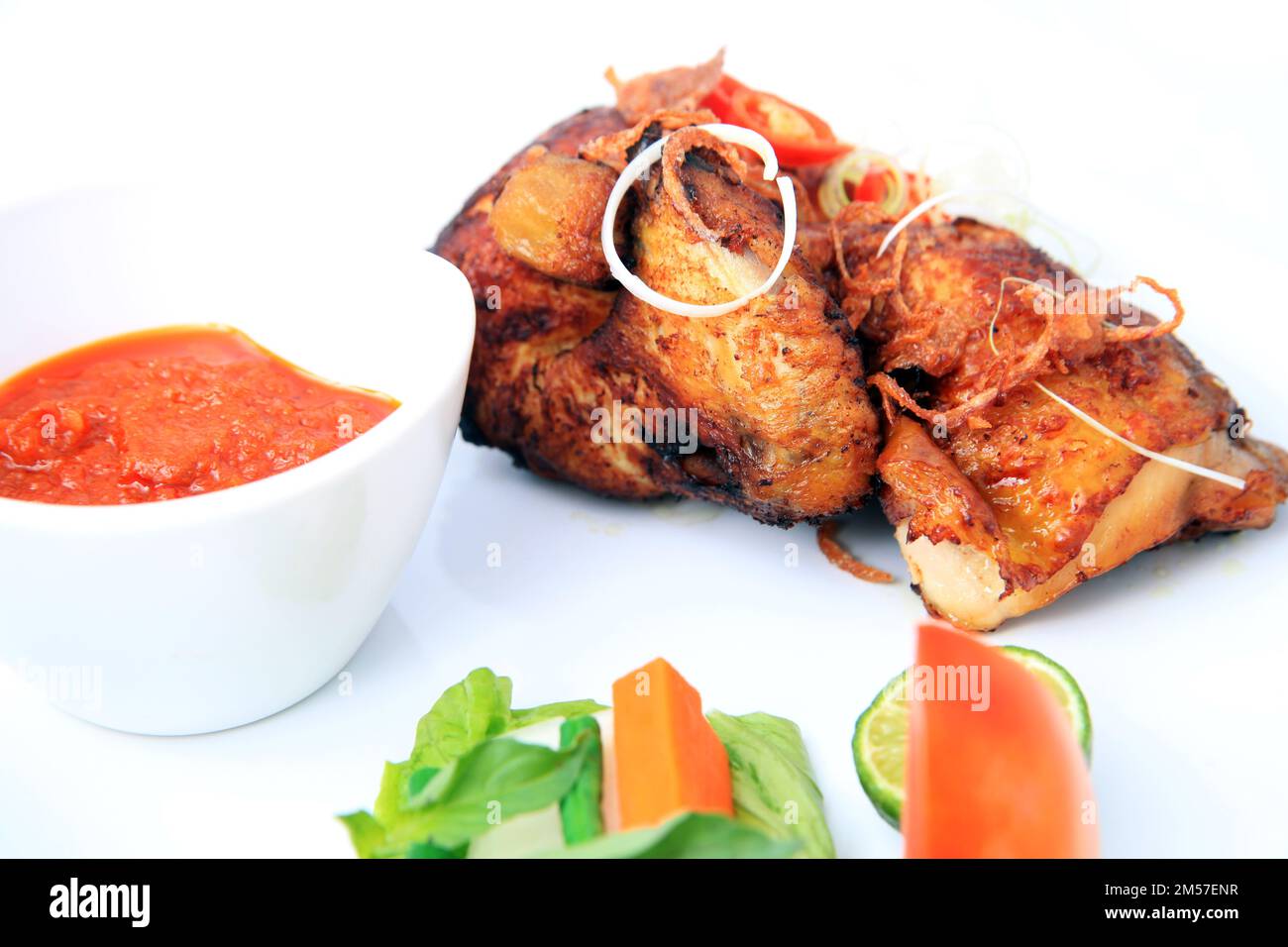 big size fried chicken portion with hot chili sauce with vegetables ...