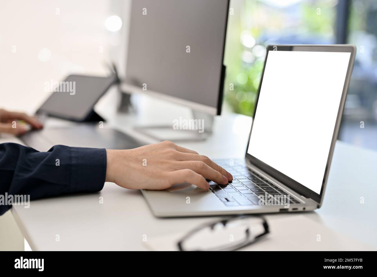 cropped and side view, Professional male programmer or web developer using laptop computer ...