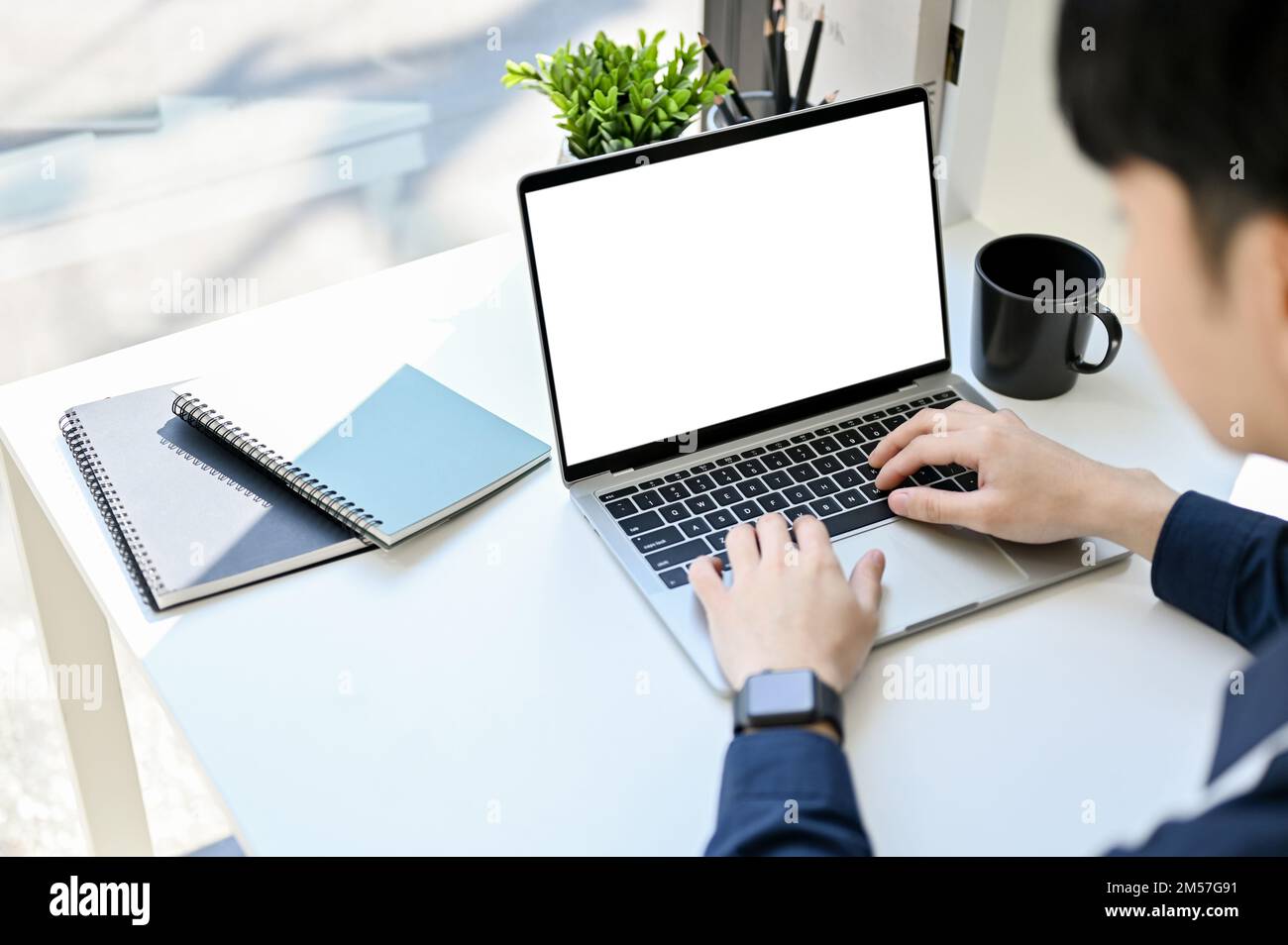 Smart young Asian man using laptop computer, typing on notebook ...