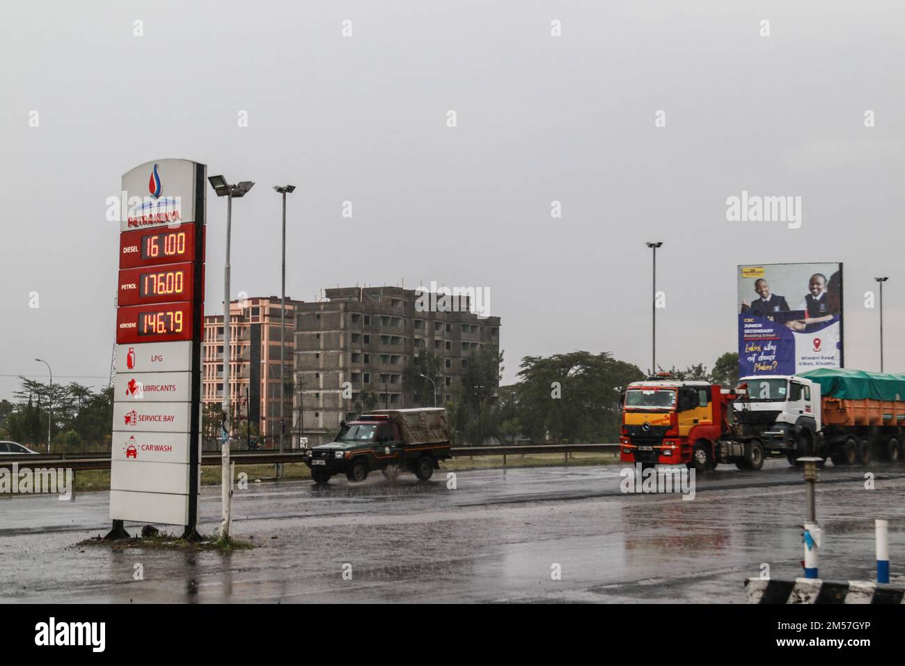 Nakuru, Kenya. 26th Dec, 2022. Vehicles are driven past a fuel price board on a busy highway in ...
