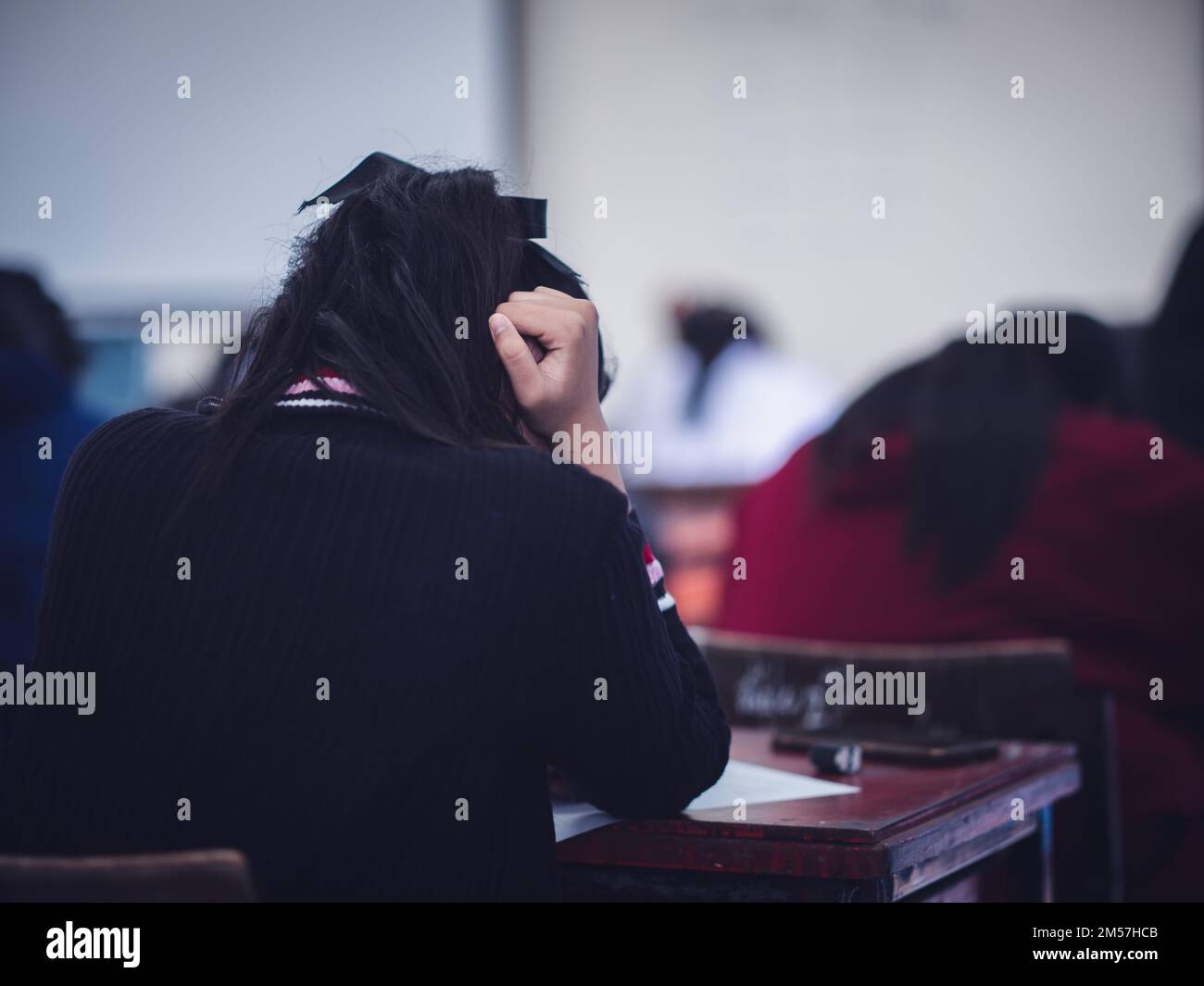 University students reading exam answer sheets exercises in classroom ...