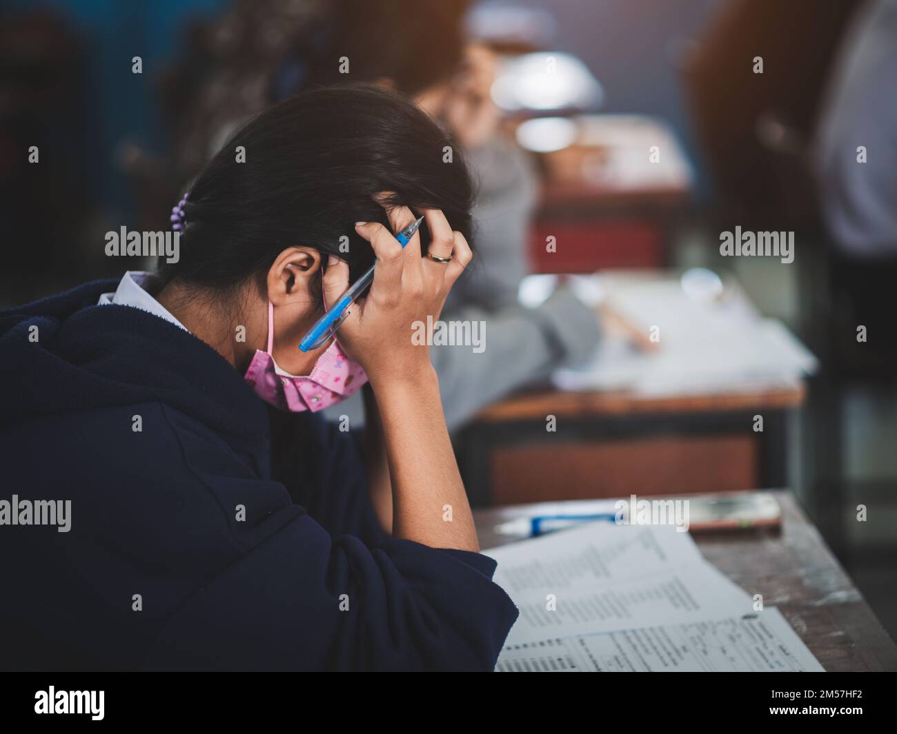 University students reading exam answer sheets exercises in classroom ...