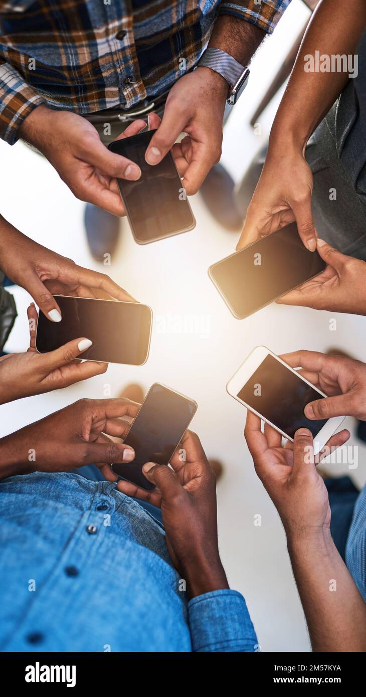Stay close, stay connected. a group of people using their smart phones ...