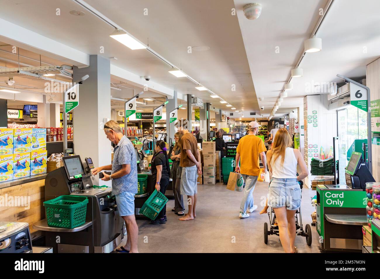 People paying for their groceries at self checkout machines in ...