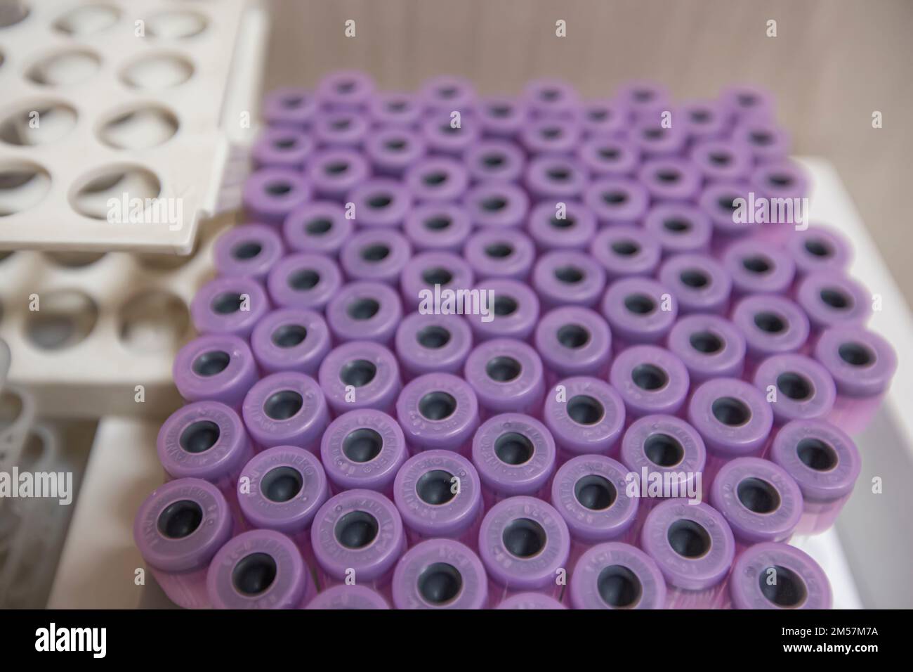 Blood sample tube from a shelf with analysis machines in the laboratory ...