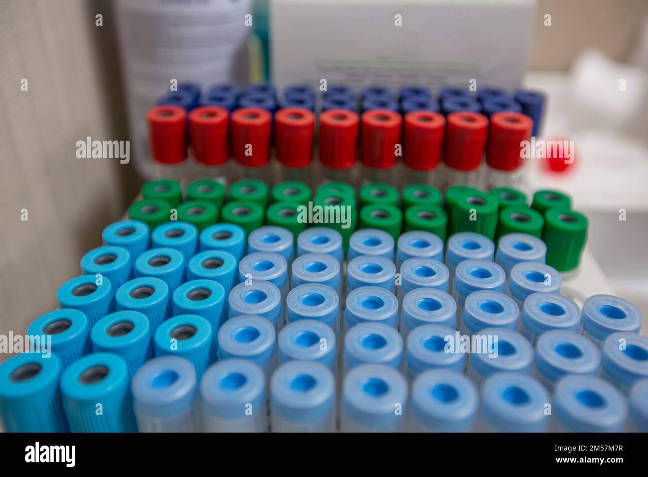 Blood sample tube from a shelf with analysis machines in the laboratory ...