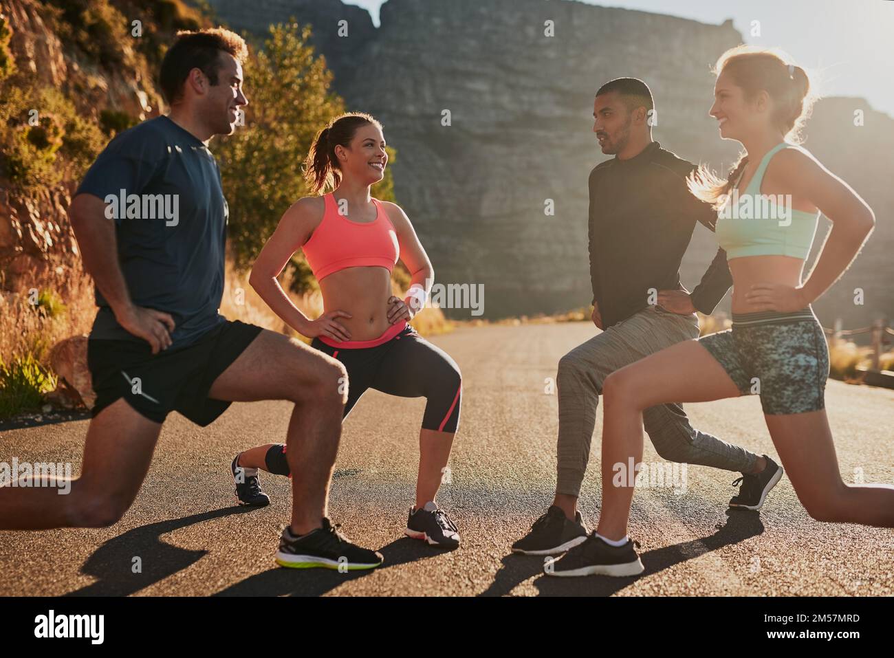 Make exercising more fun. a group of friends stretching before their ...