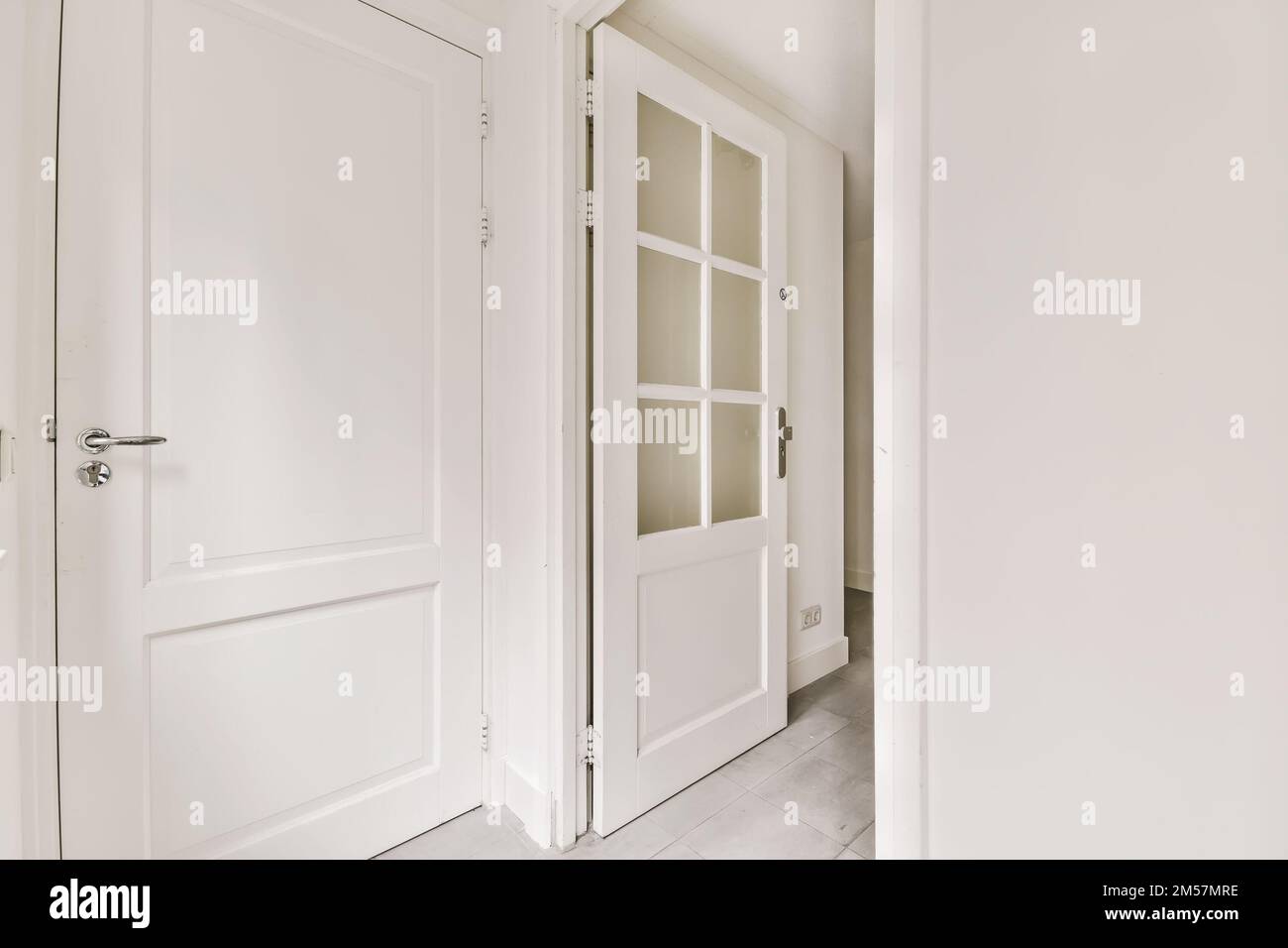 an empty room with two doors and one door opened to reveal the other ...