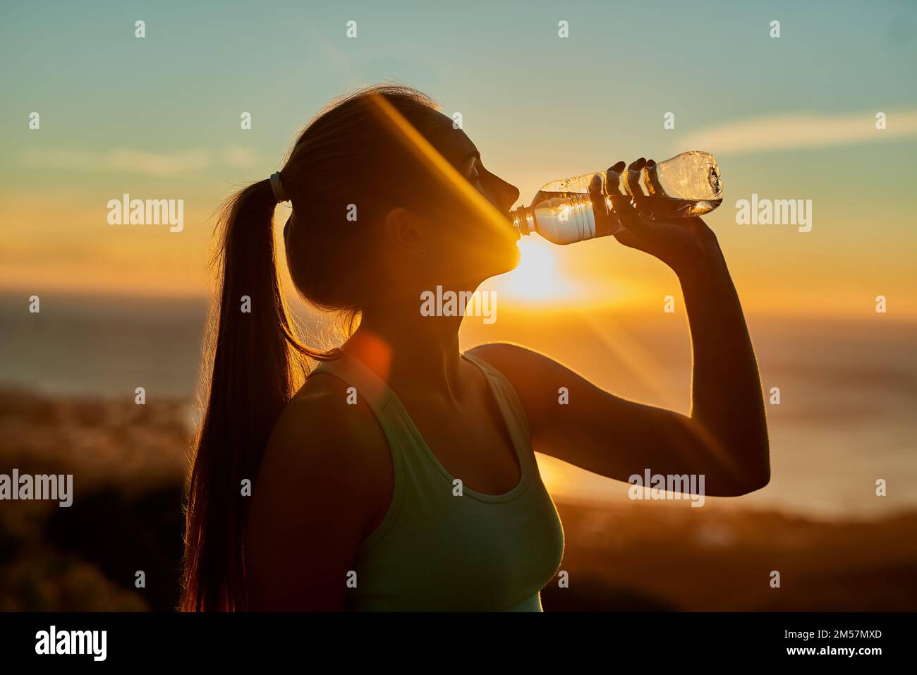 Taking in some liquids. an attractive young woman getting a drink ...