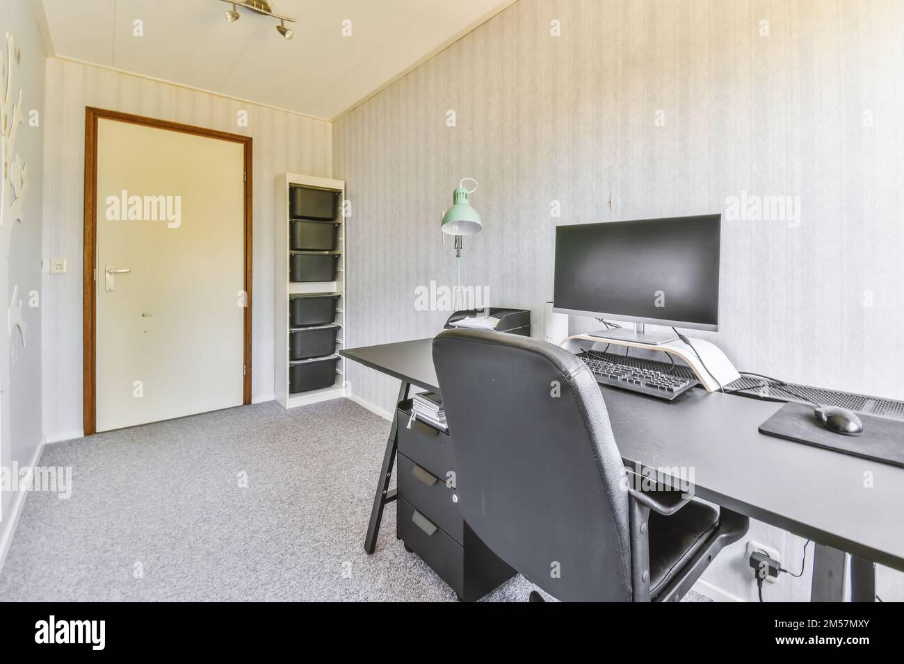 an office space with a computer, monitor and keyboard on the desk in ...